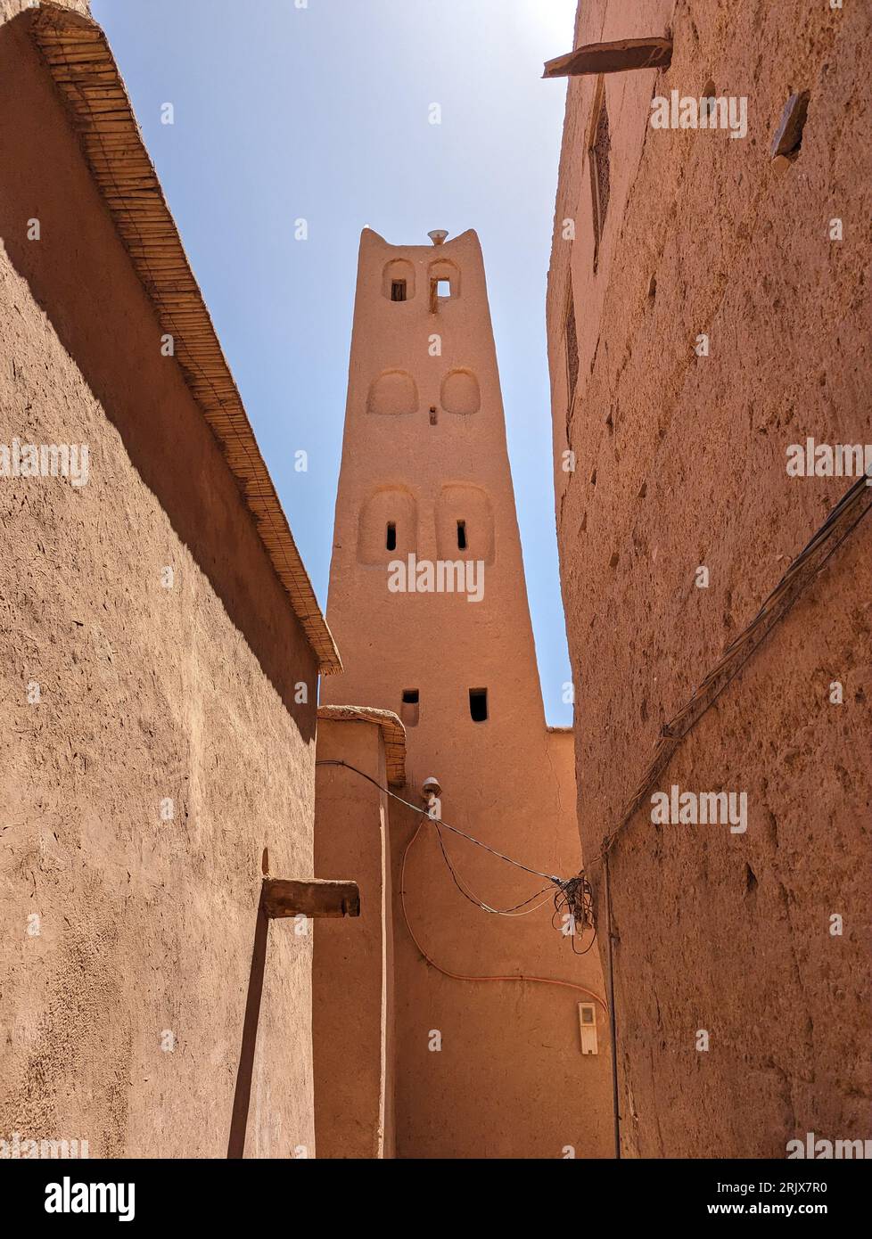 Minaret of a historic mosque built of clay in the ancient city center ...