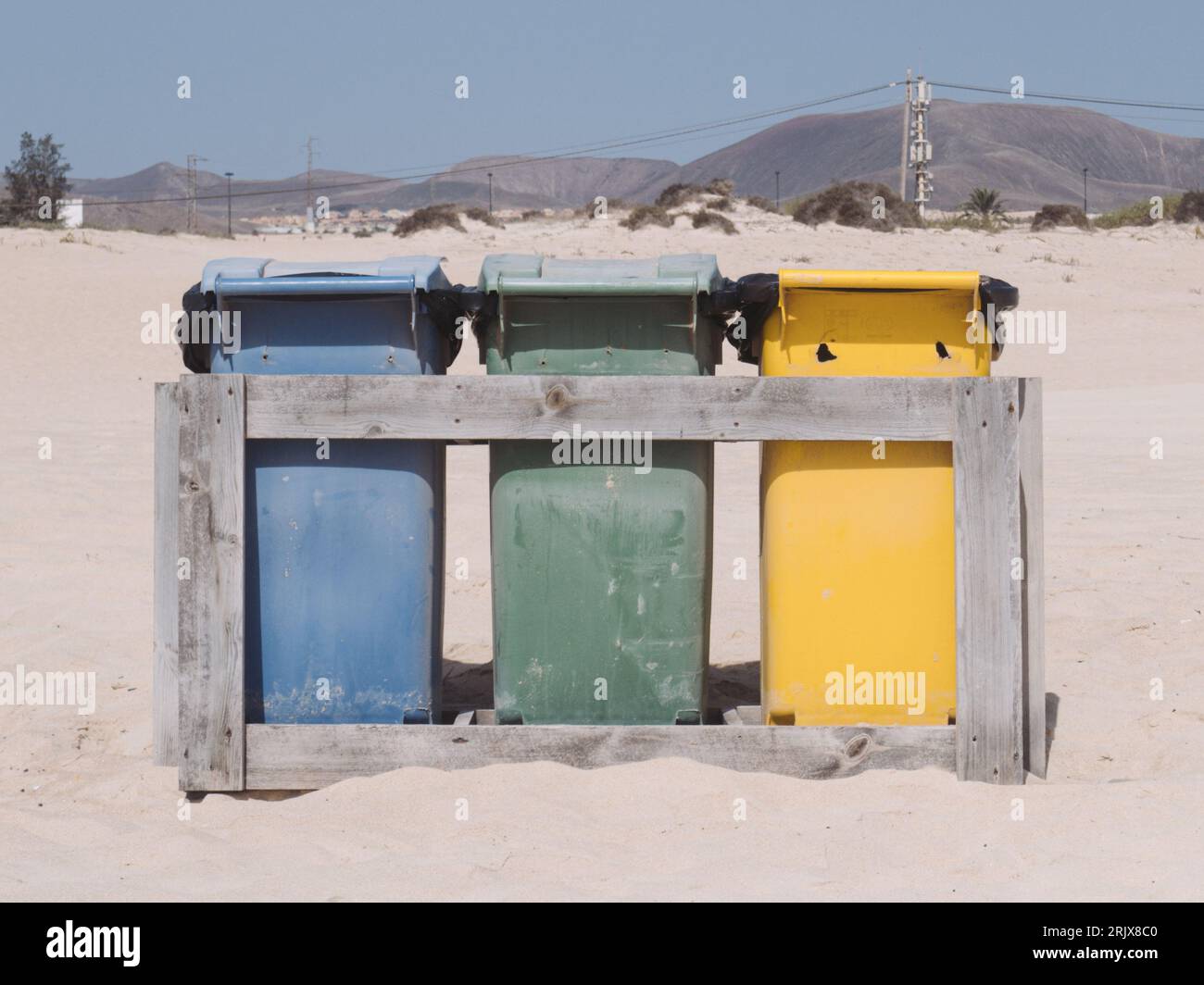 Recycle bins on a clean sand beach. Reduces rubbish and helps save the ...