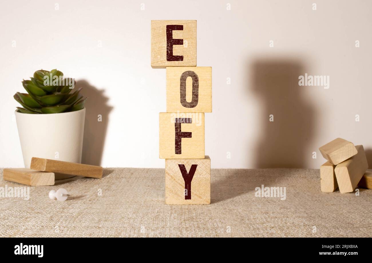 EOFY, End of Financial Year text. wood cubes and white background Stock ...
