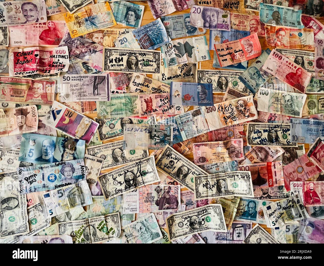 Collection of paper currency from around the world pinned to a bulletin ...