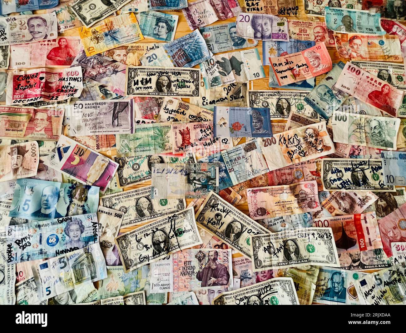 Collection of paper currency from around the world pinned to a bulletin ...