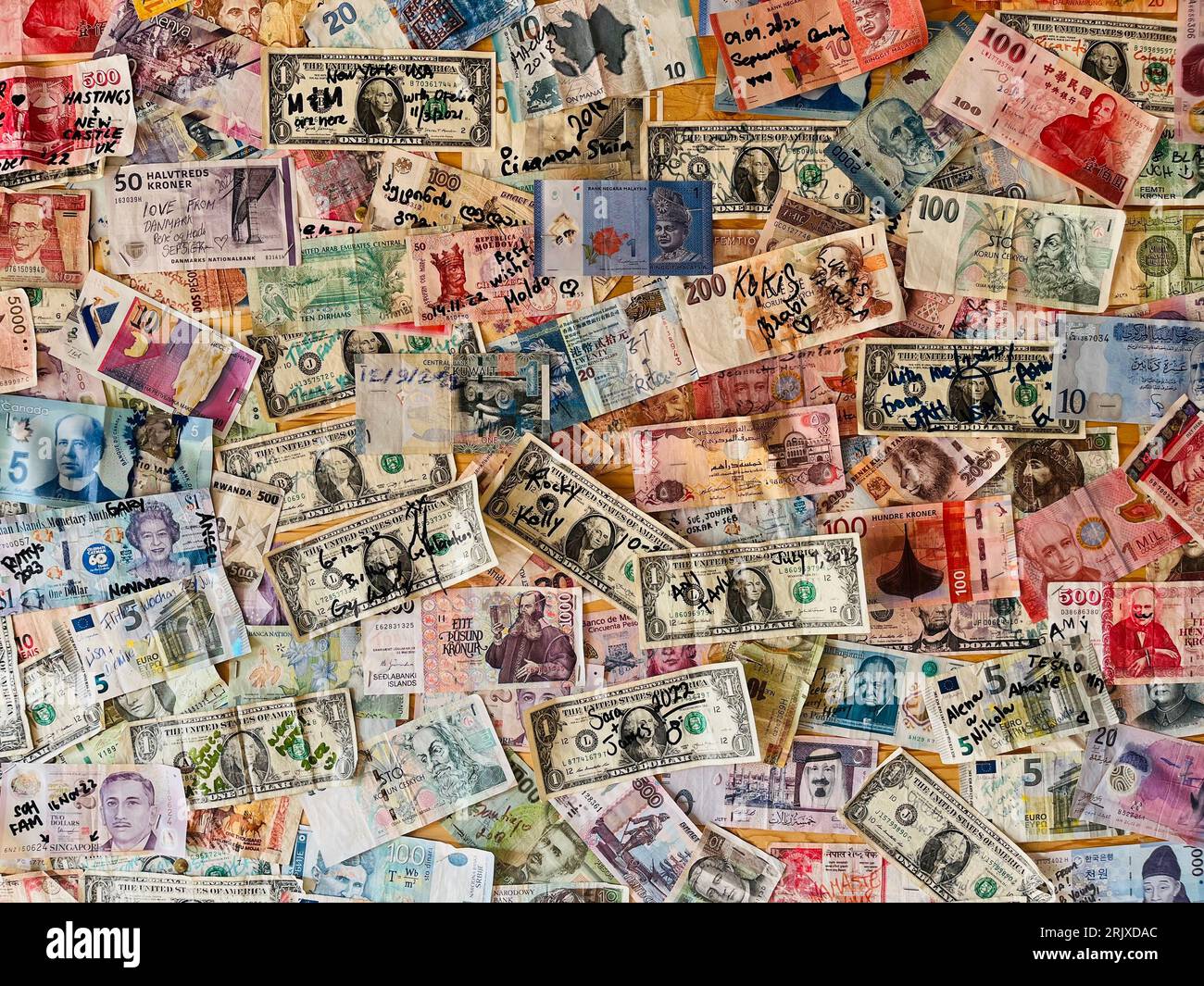 Collection of paper currency from around the world pinned to a bulletin ...