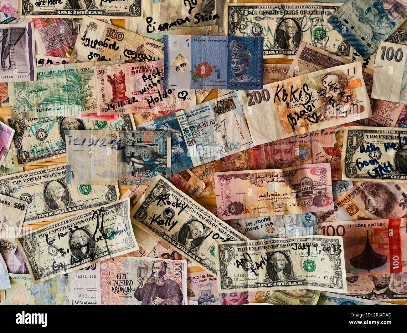 Collection of paper currency from around the world pinned to a bulletin ...