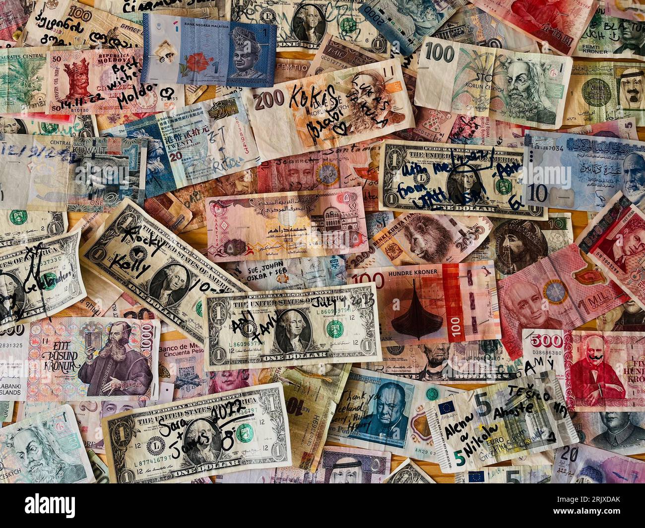 Collection of paper currency from around the world pinned to a bulletin ...