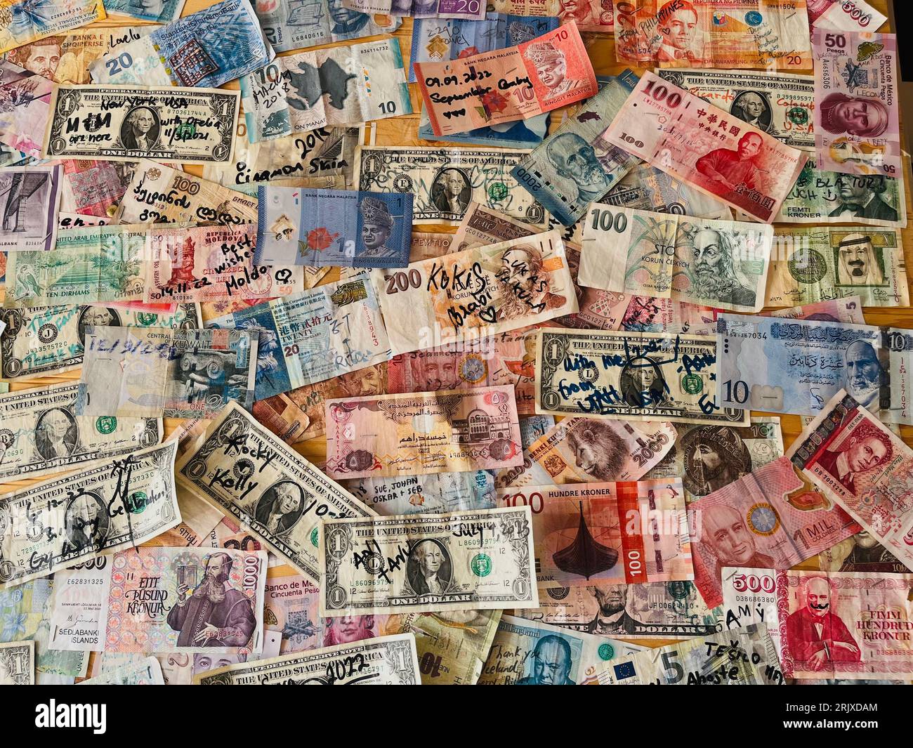 Collection of paper currency from around the world pinned to a bulletin ...