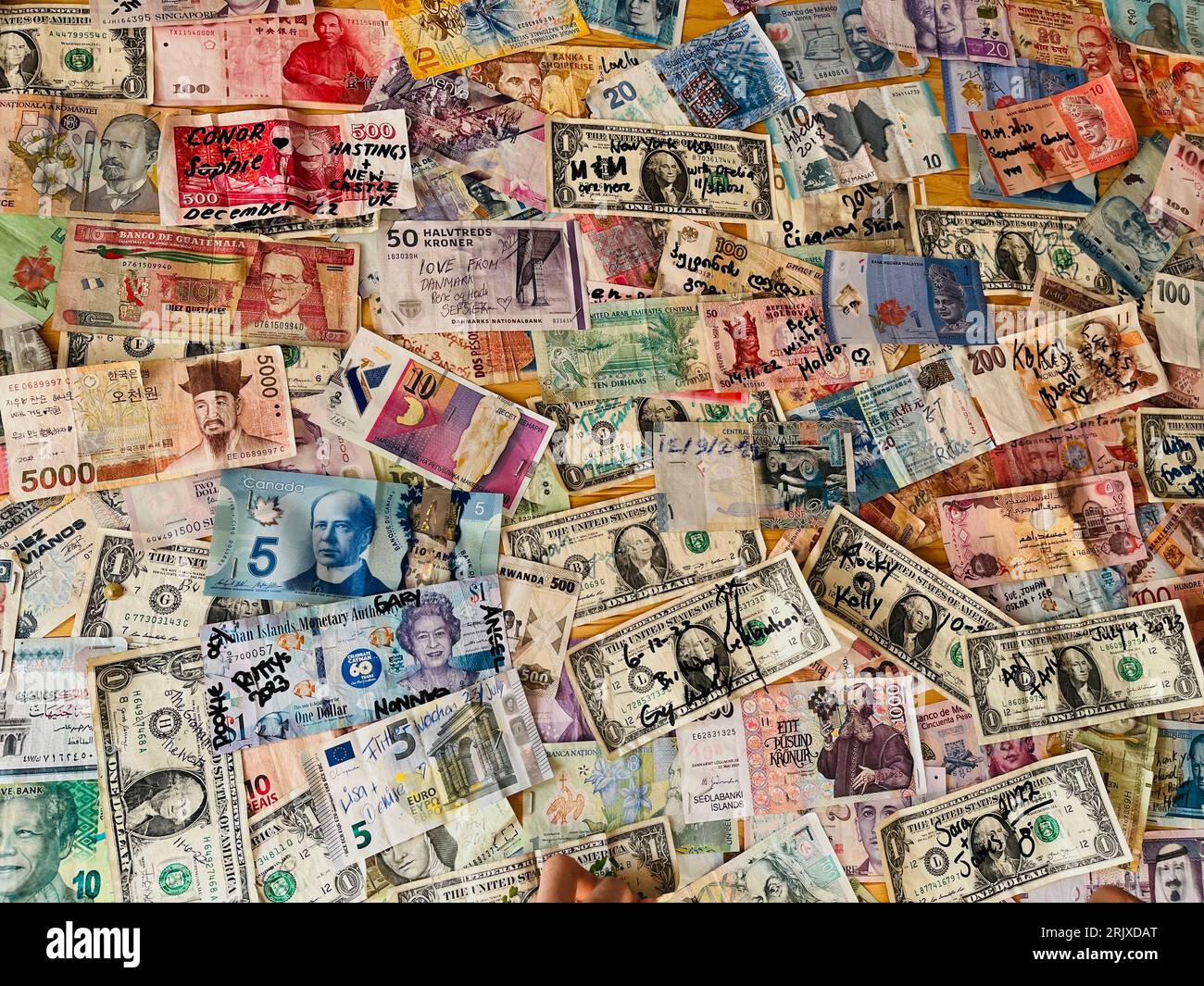 Collection of paper currency from around the world pinned to a bulletin ...