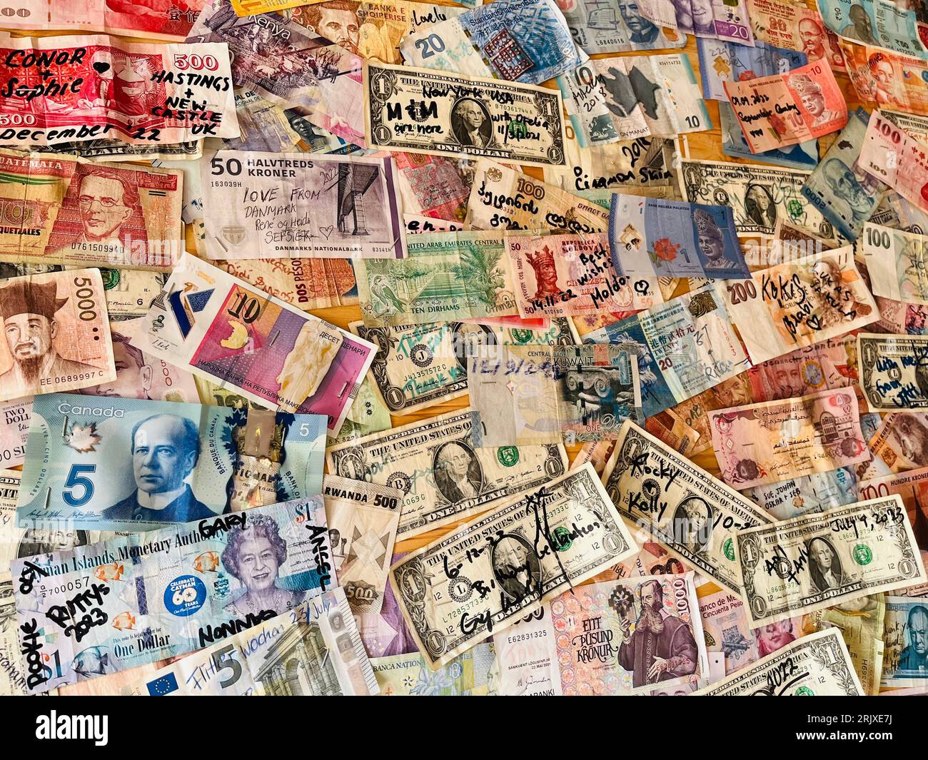 Collection of paper currency from around the world pinned to a bulletin ...