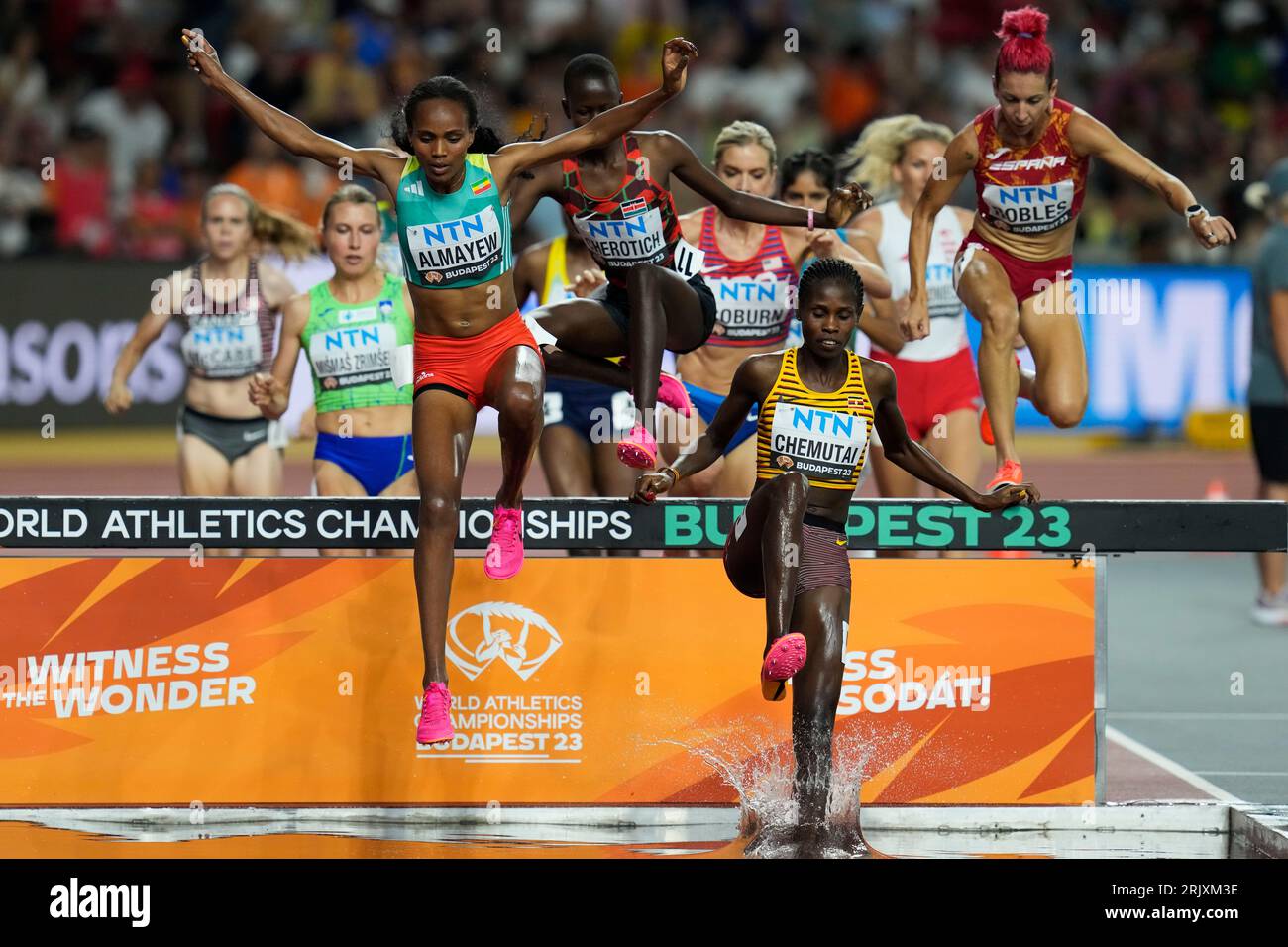 Sembo Almayew, of Ethiopia, Peruth Chemutai, of Uganda, compete in the ...
