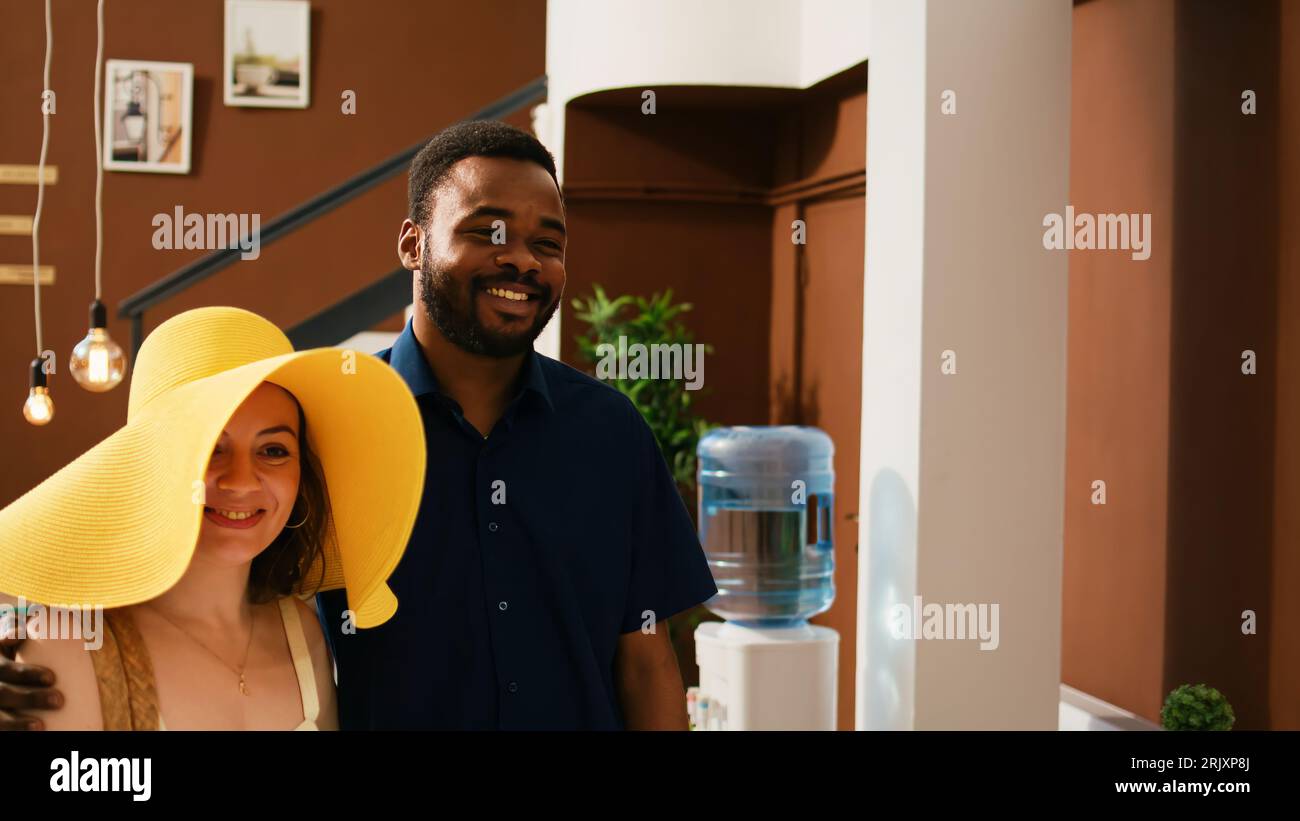 Travellers at reception lobby in hotel, arriving on summer vacation at ...