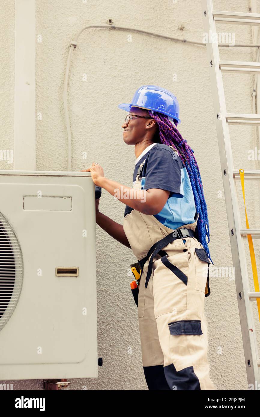 African american engineer dissasembling outdoor air conditioner metal ... African american engineer dissasembling outdoor air conditioner metal ...