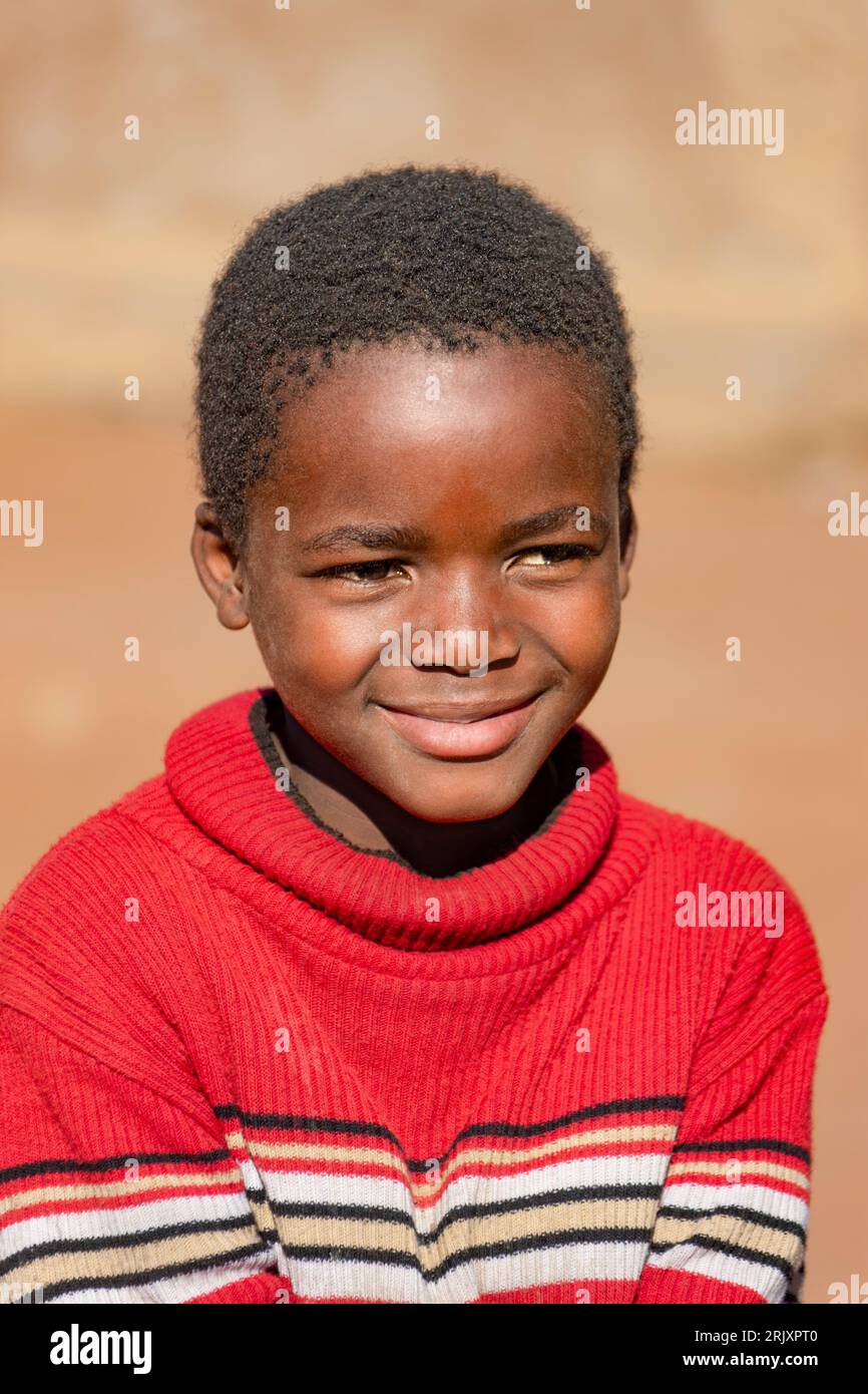 portrait of african smiling child in the village, standing in the ...
