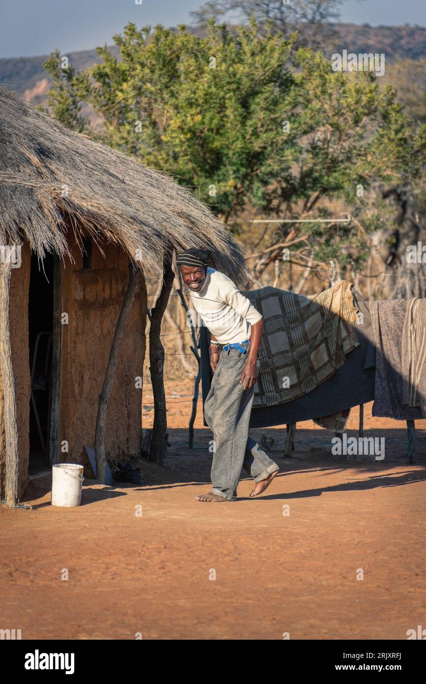 African man in the village, walking in the yard to enter his hut Stock ...