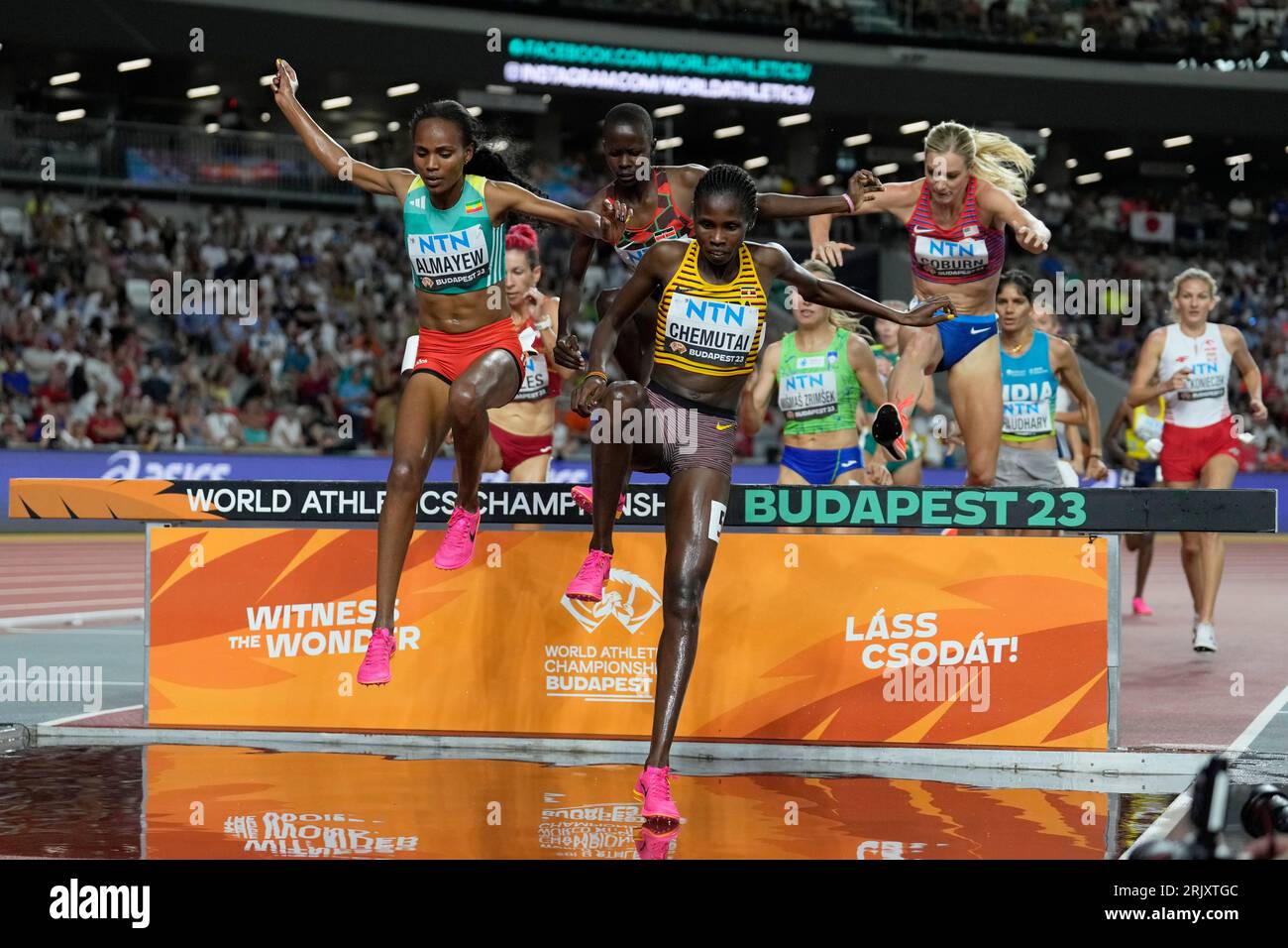 Sembo Almayew, of Ethiopia, left, and Peruth Chemutai, of Uganda ...