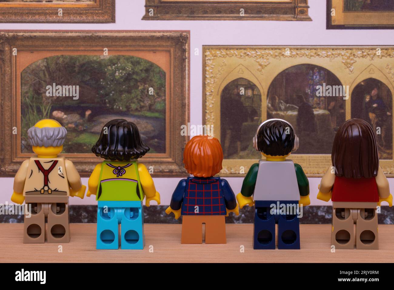 Five assorted Lego pieces arranged on a tabletop next to several ...