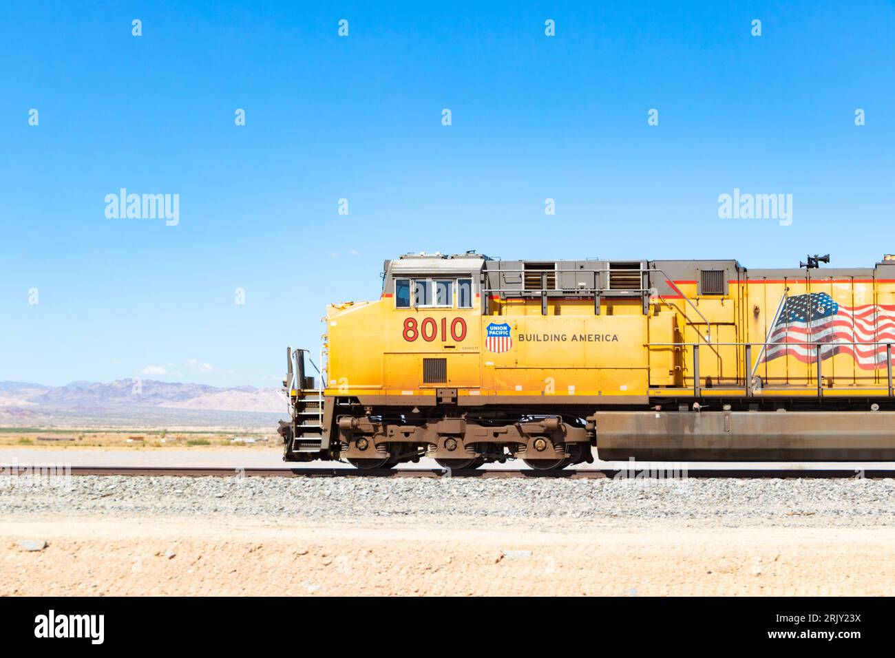 side view of yellow freight train engine locomotive 8010 crossing the ...