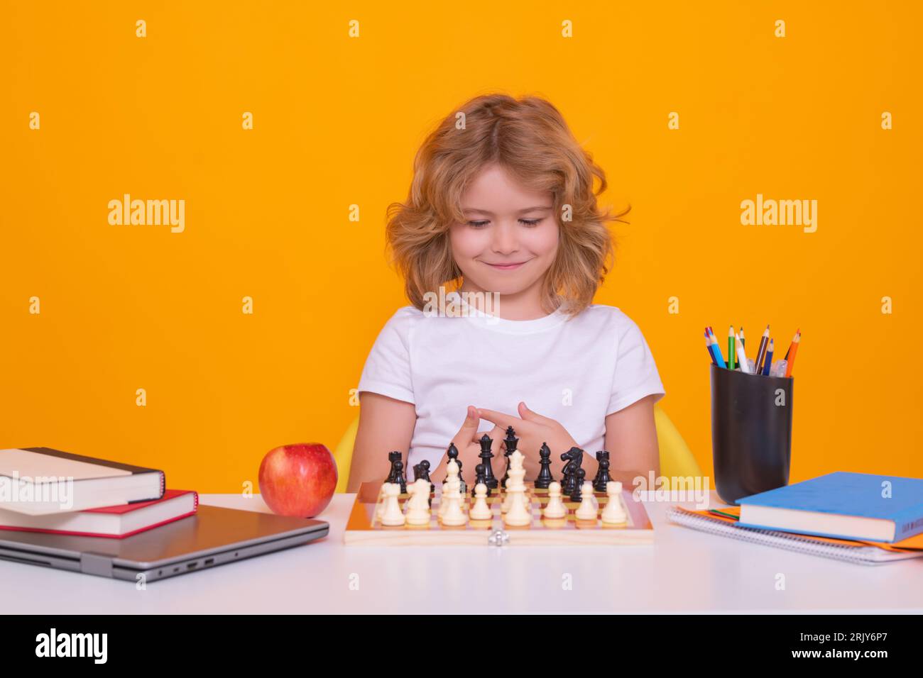 Child play chess on studio background. Kid playing chess. Clever child ...