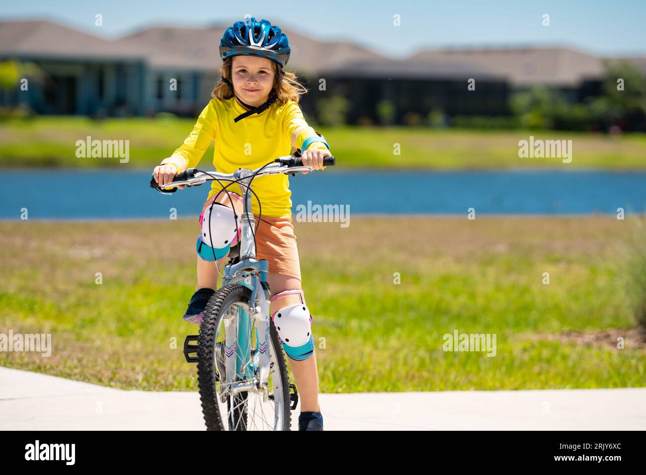 Boy in a helmet riding bike. Boy in safety helmet riding bike in city ...
