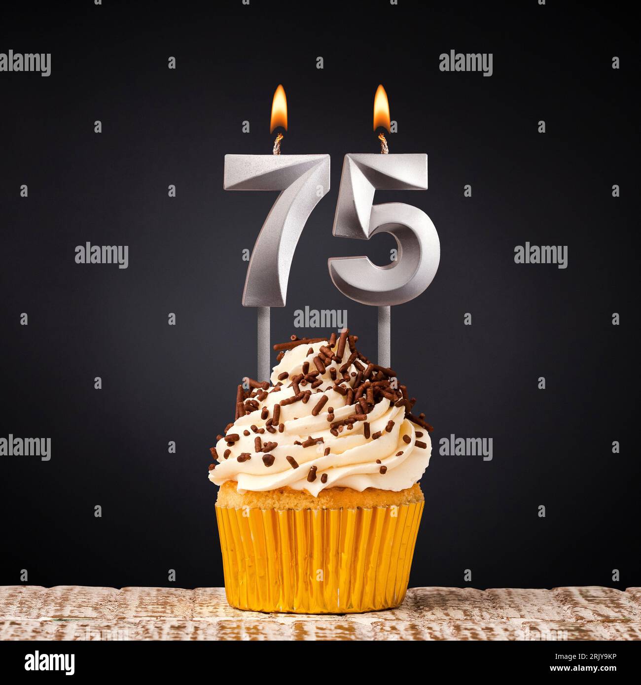 Birthday candle number 75 - Anniversary cupcake on black background ...