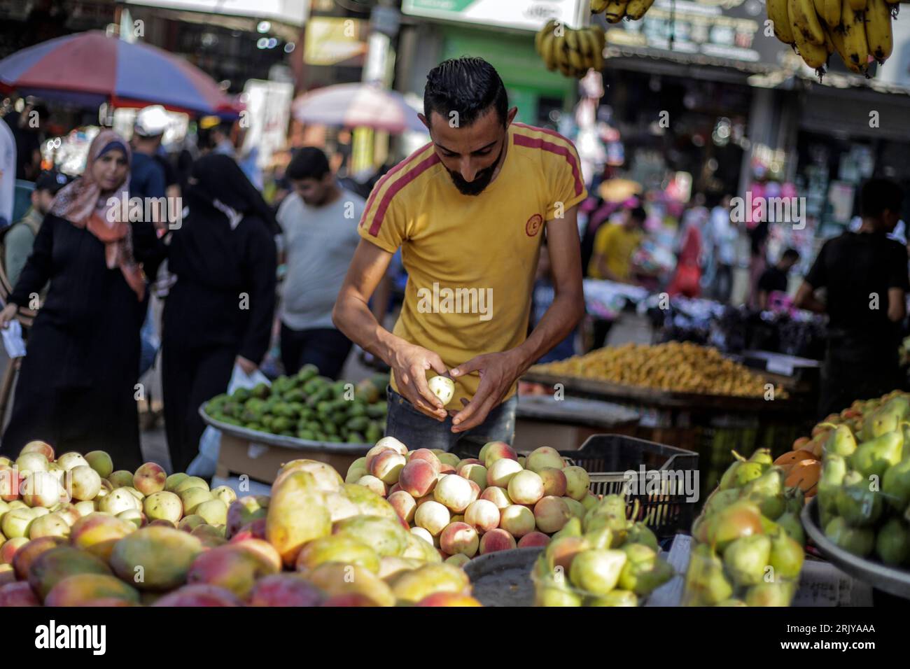 A Palestinian man sells fruits at the market in Gaza City Stock Photo ...