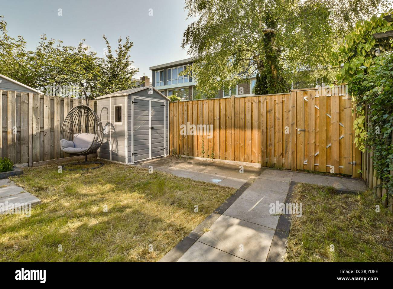 a backyard area with a swing in the middle part of the yard, and a ...