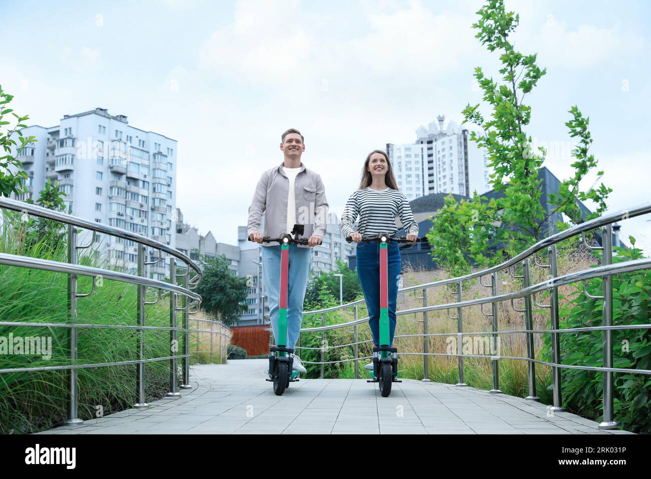 Man woman ride electric scooters hi-res stock photography and images ...