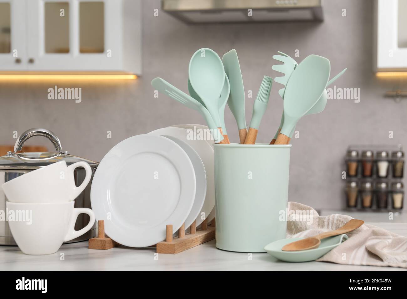 Set of different kitchenware on white table at home Stock Photo - Alamy
