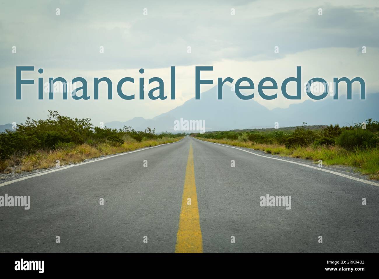 Way to financial freedom. Words over asphalt road Stock Photo - Alamy