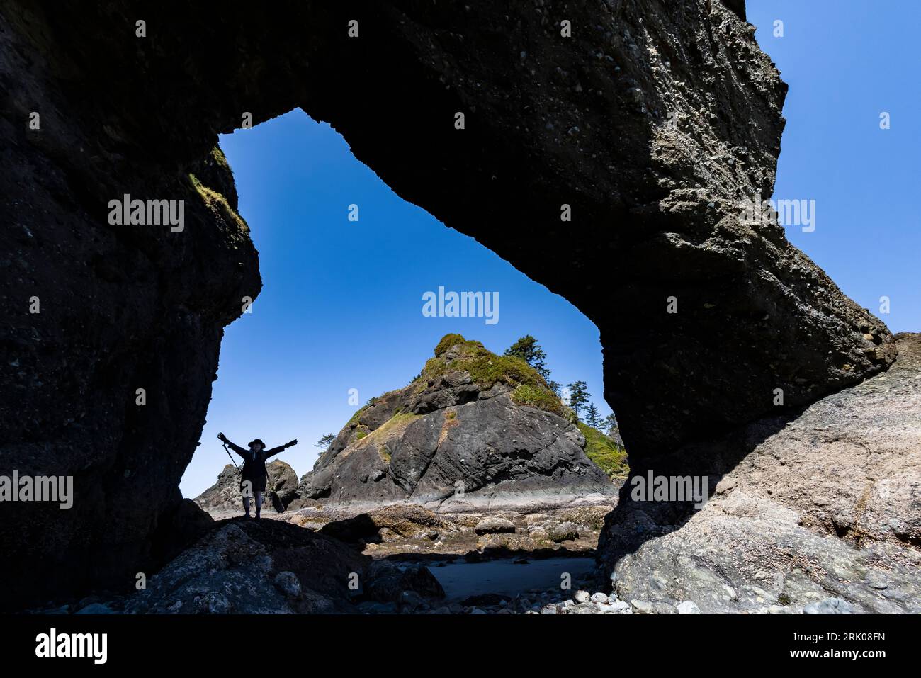 Hikers can walk under a big arch at low tide at Point of Arches ...