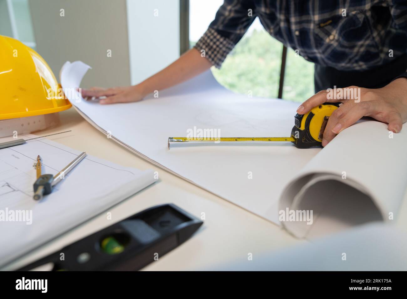 architect working with blueprints, engineer inspection in workplace for ...