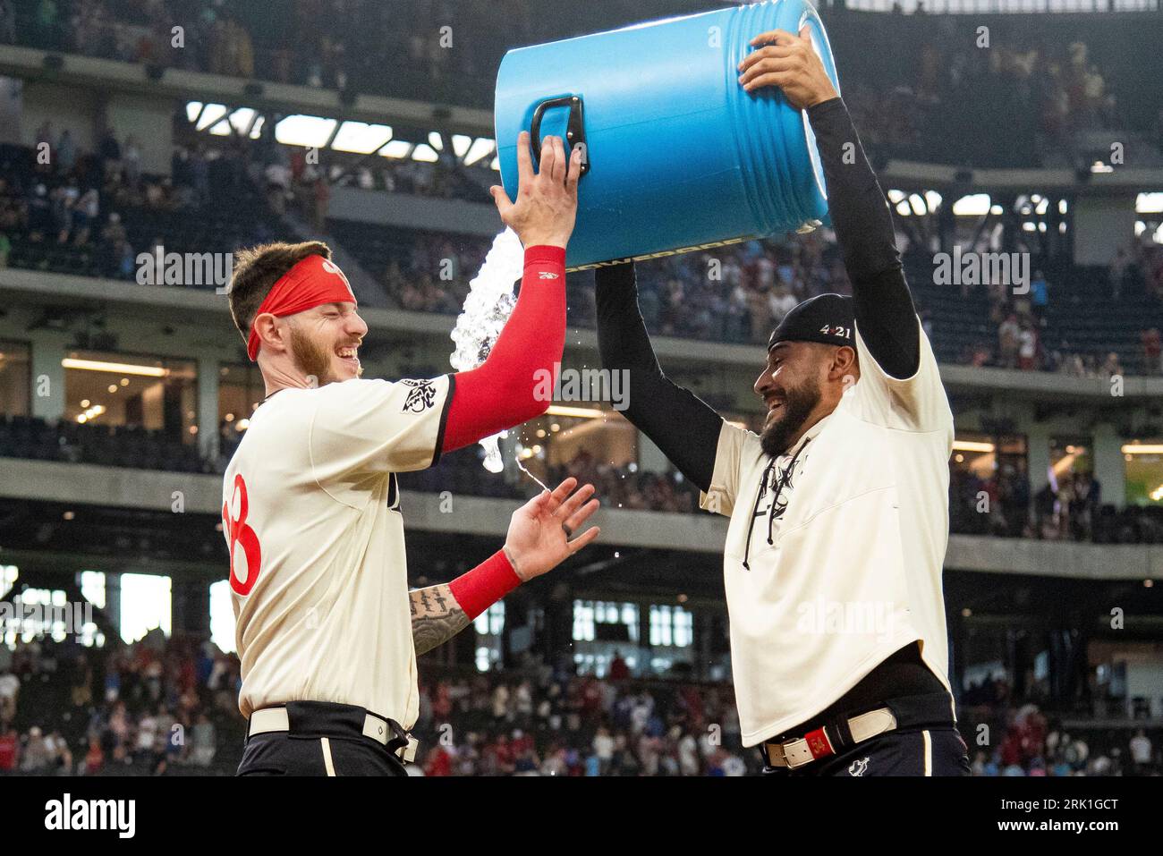 Texas Rangers catcher Jonah Heim (28), right, smiles as he is doused ...
