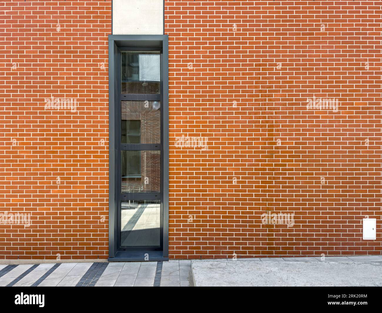 red brick wall of old renovated building with large window ...