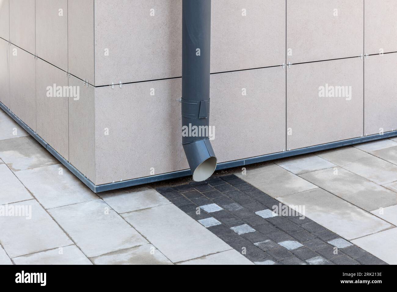 corner of modern building with gray metal drainpipe Stock Photo - Alamy