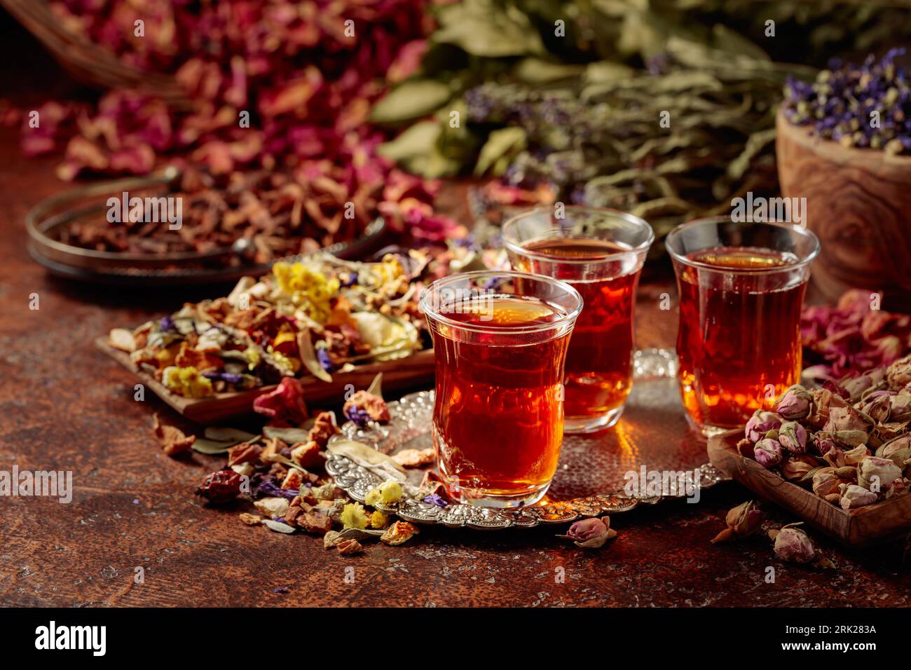 Herbal tea and a mix of various dried medicinal plants and herbs on a ...