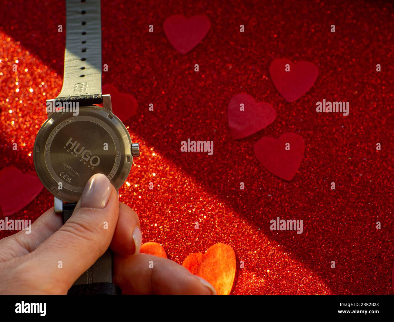 Black watch is on red heart paper background Stock Photo - Alamy