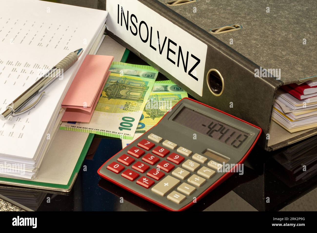 Symbol image of insolvency: Folders, calculators and euro banknotes ...