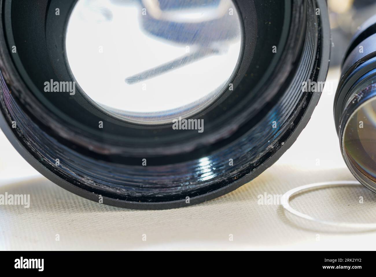 Clean and disassemble the lens for photography into its component parts ...