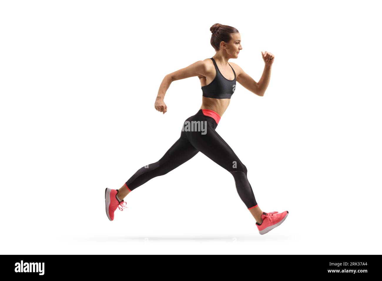 Full length profile shot of a fit young woman running isolated on white ...