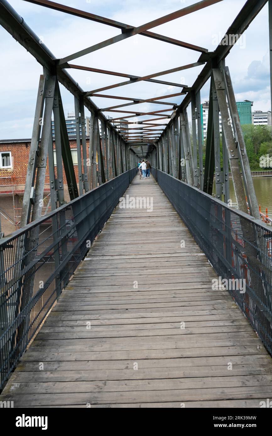 Metal pattern bridge over Neckar River, building blue sky background ...