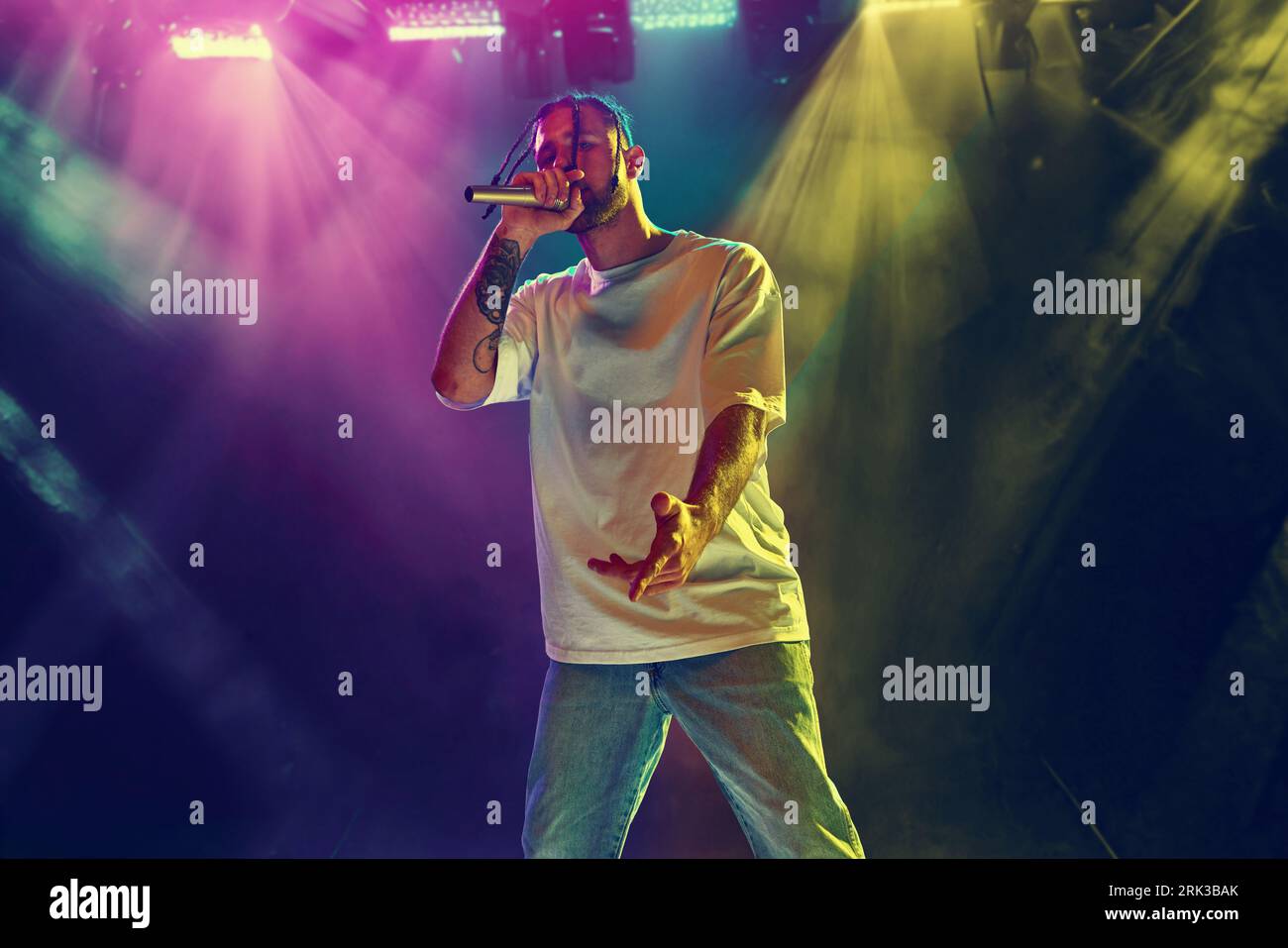 Young artistic man, musician making live concert, singing, dancing on ...