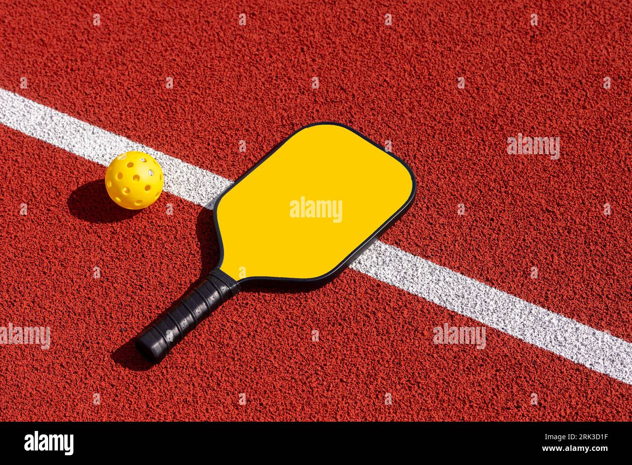 Pickleball racket and ball on orange background. Horizontal education ...