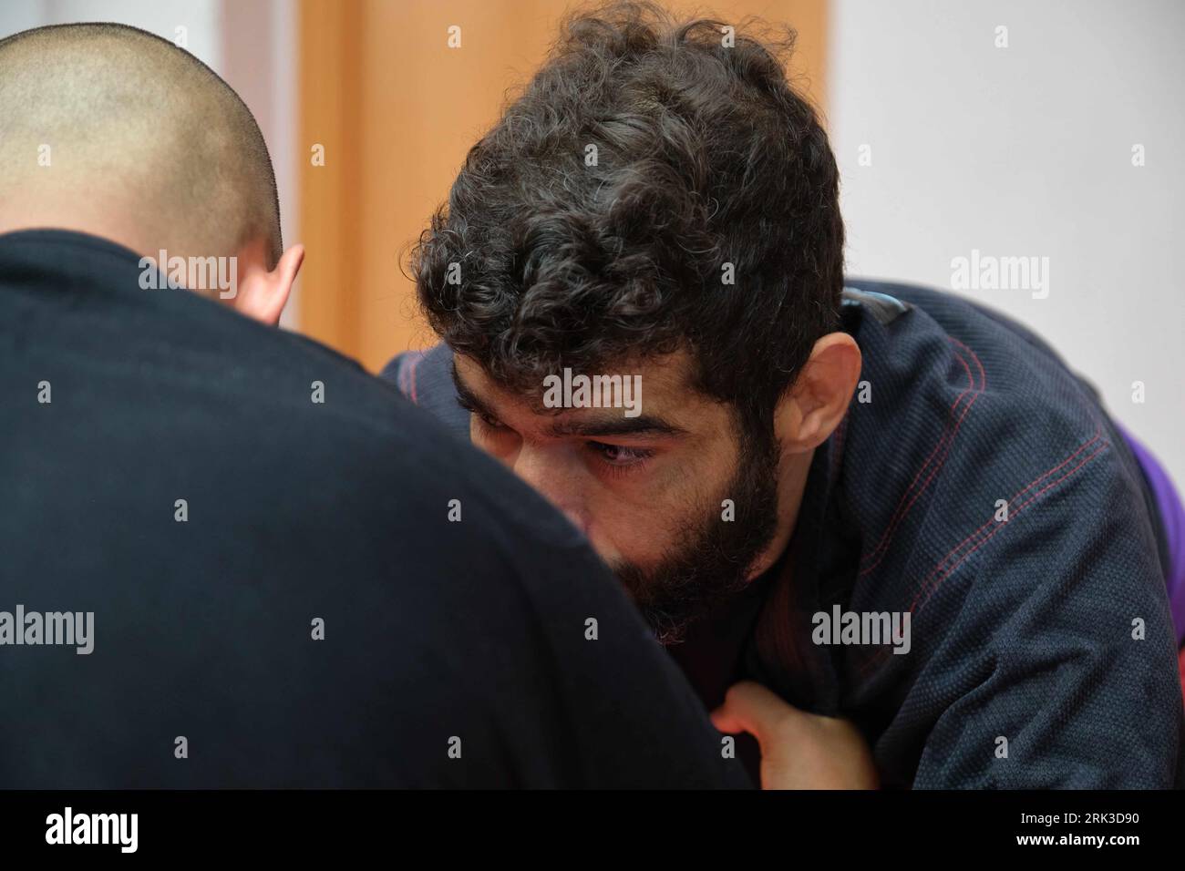 Two men practicing Brazilian Jiu-Jitsu sparring at the Academy Stock ...