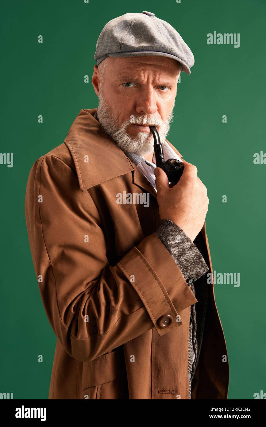 Portrait of confident and strict man, detective wearing vintage hat ...