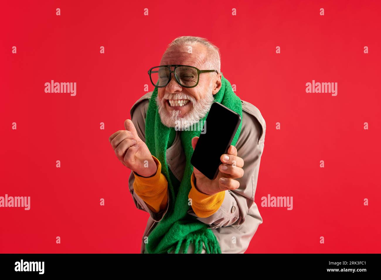 Portrait of funny elderly man with beard looking at camera clenching ...