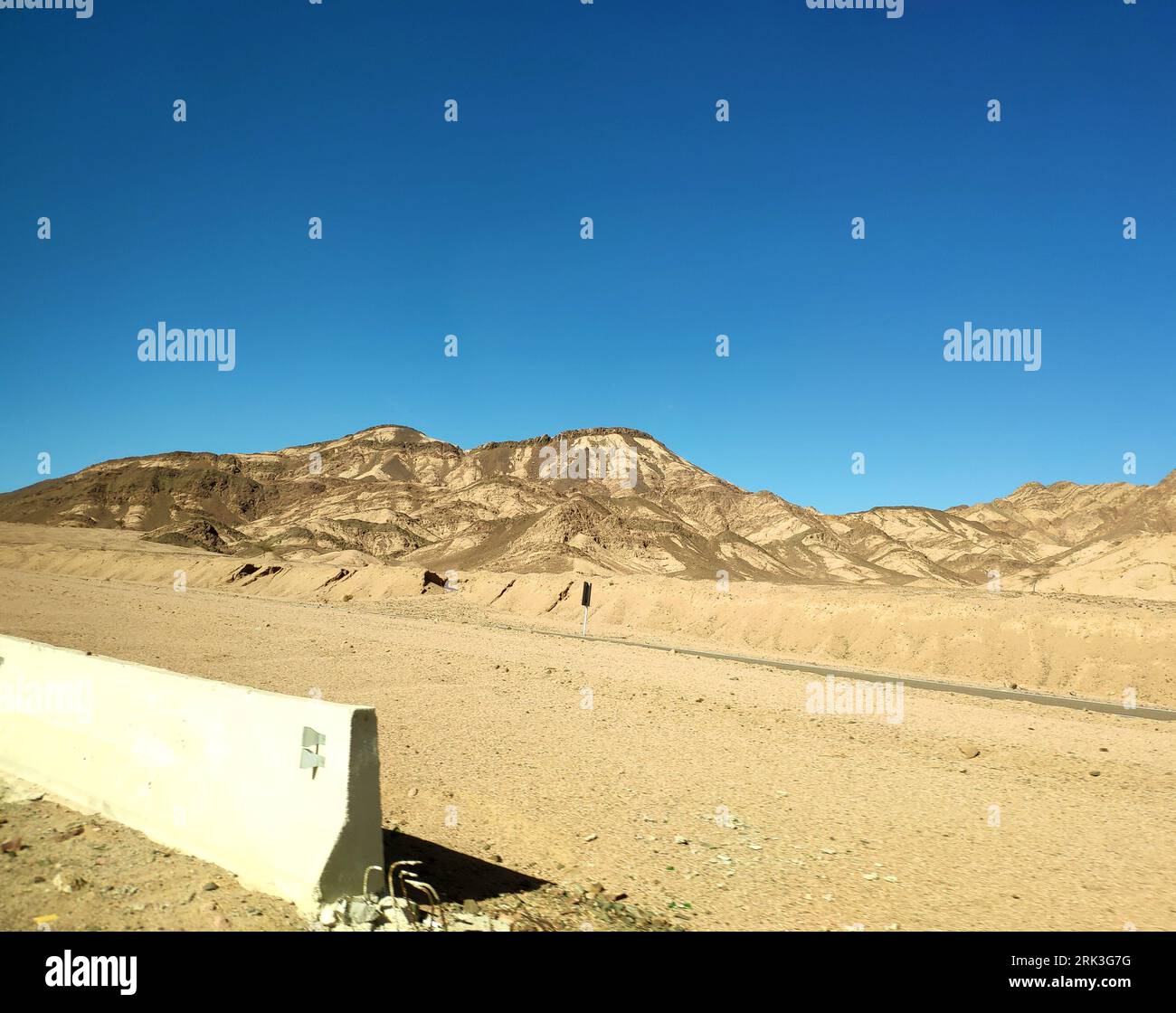Border line in the desert, picturesque background with mountains and ...