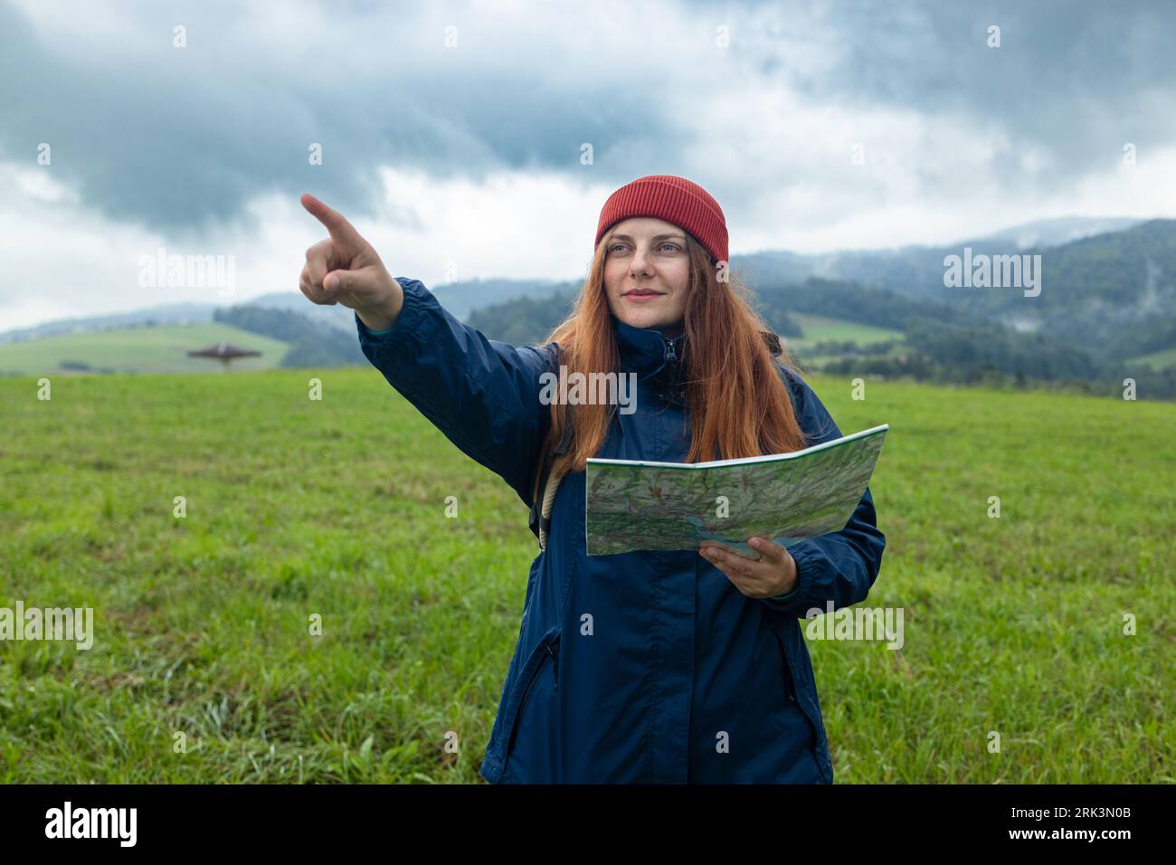 Happy 30s woman with map hiking in woods. Adventure women pointing ...