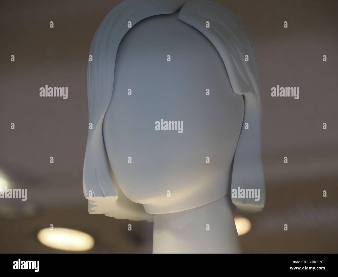 A Female mannequin in shop window. woman Head dummy shows fashionable ...