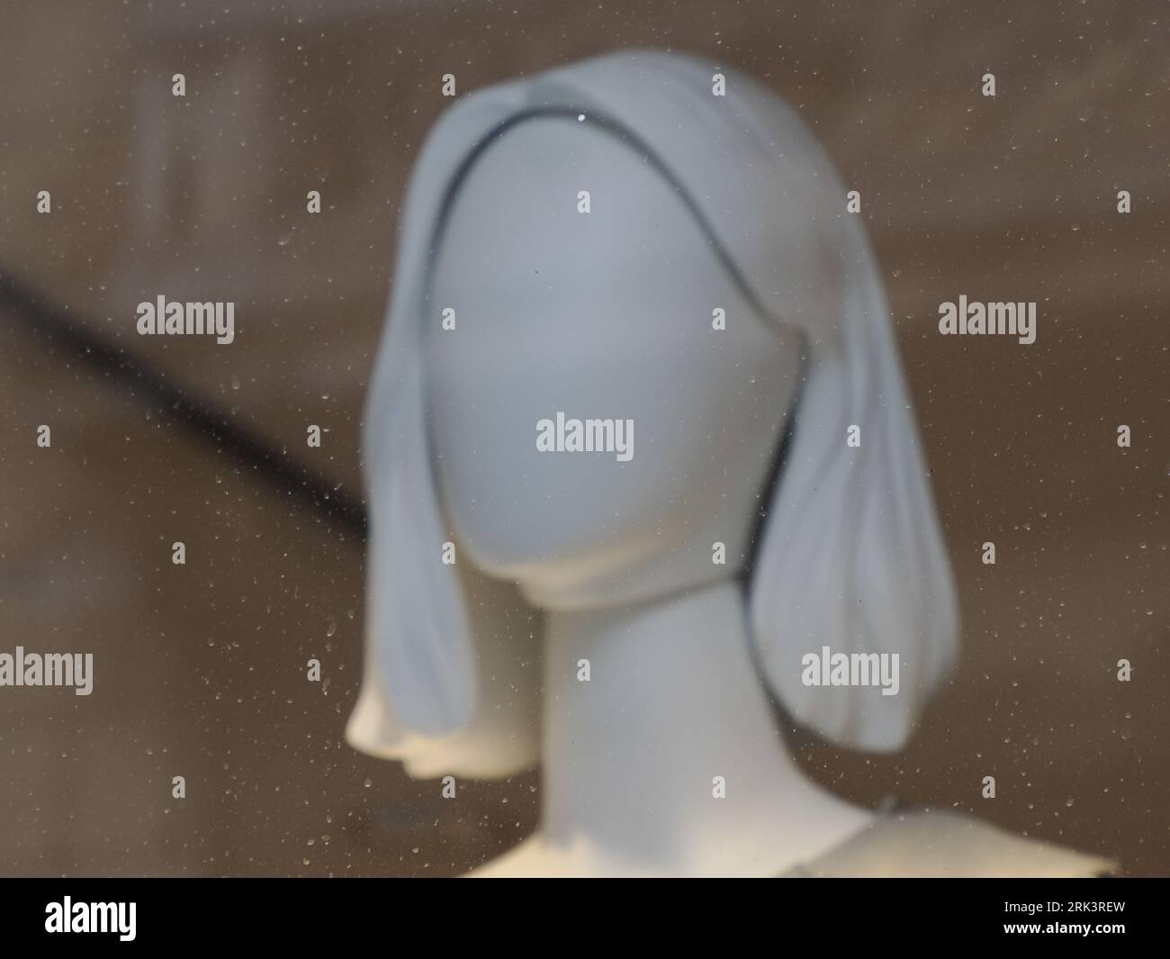 A Female mannequin in shop window. woman Head dummy shows fashionable ...