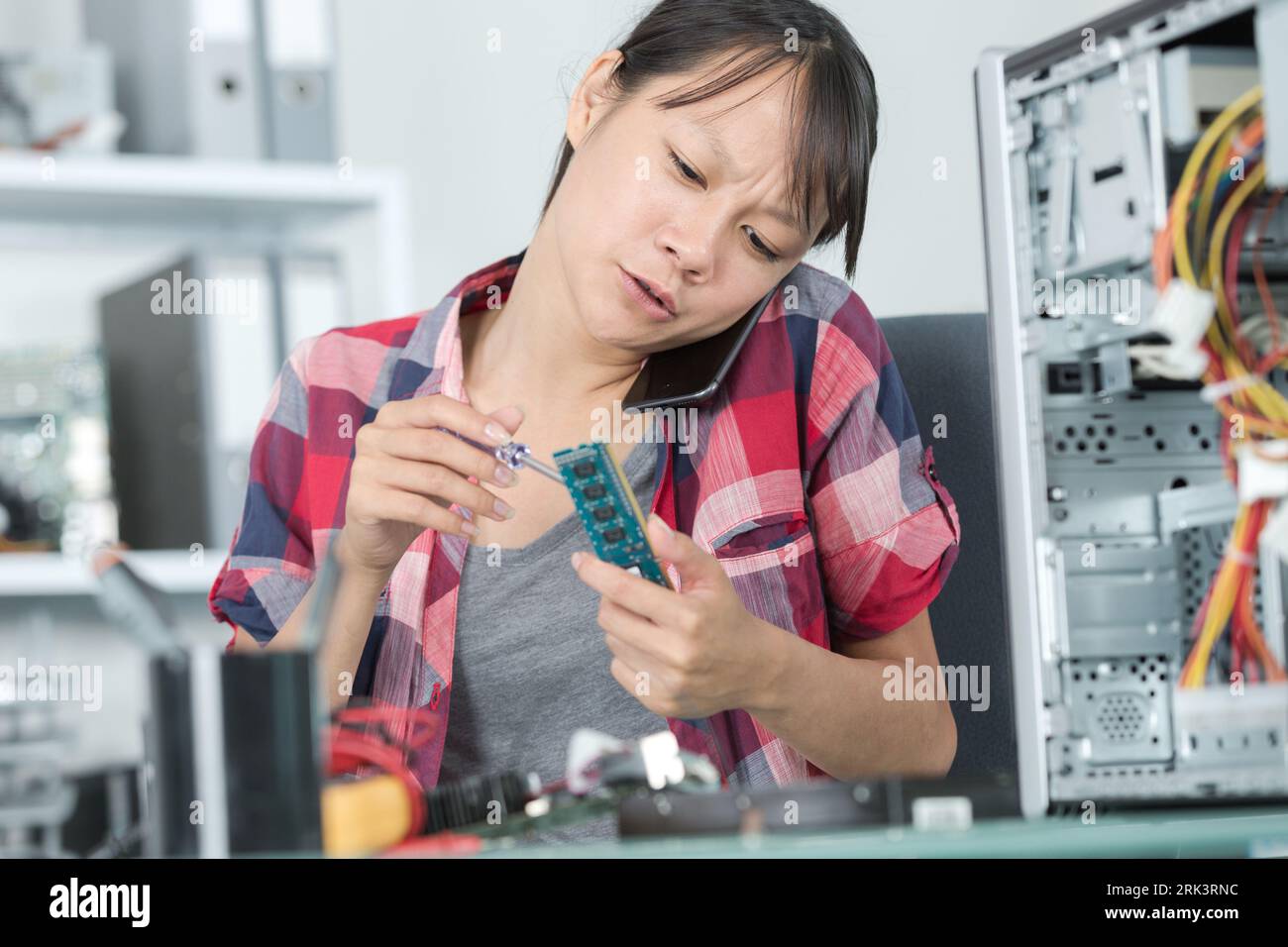 professional computer engineer talking to customer while fixing pc ...