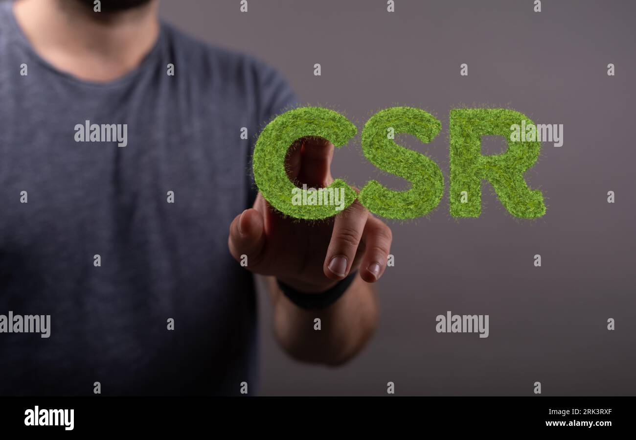 A man pointing at a grassy text reading 'CSR', the concept of Corporate ...