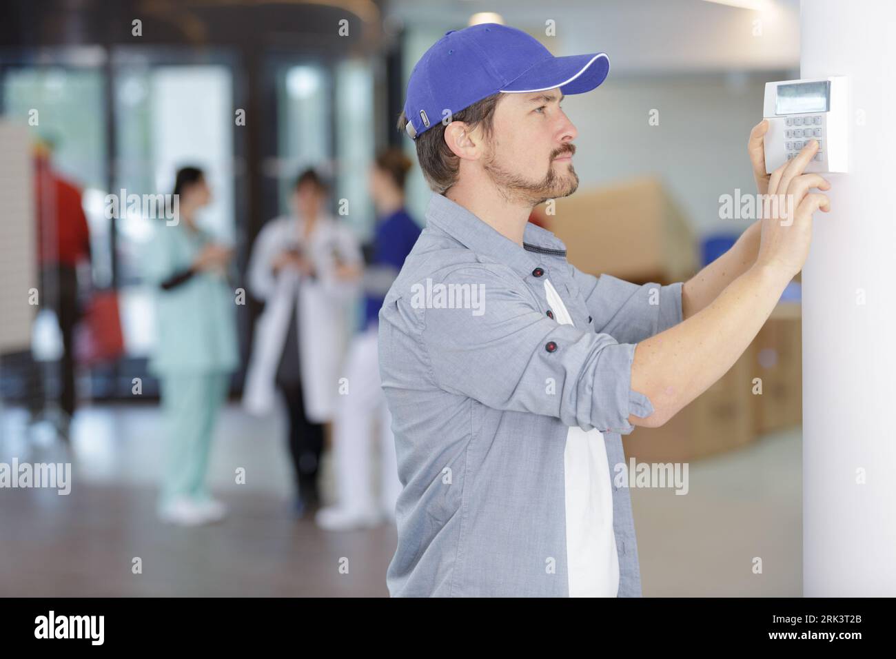 worker installing alarm system in hospital Stock Photo - Alamy